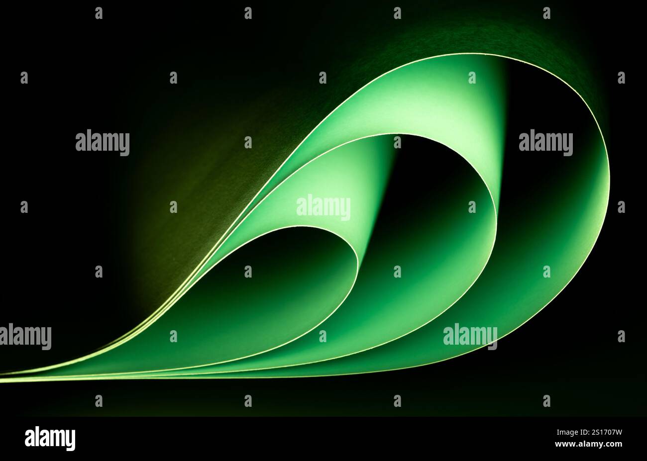 Curved shapes in vibrant green and black blend together harmoniously ...
