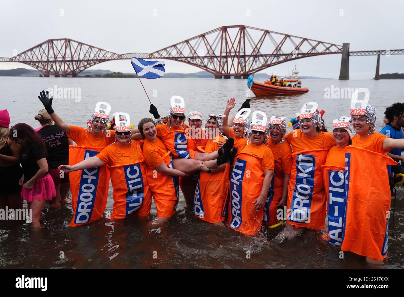People take part in the Loony Dook New Year's Day dip in the Firth of ...