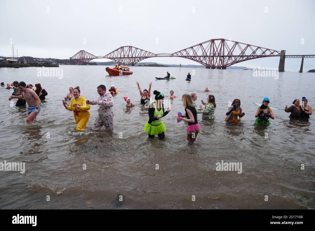 People take part in the Loony Dook New Year's Day dip in the Firth of ...