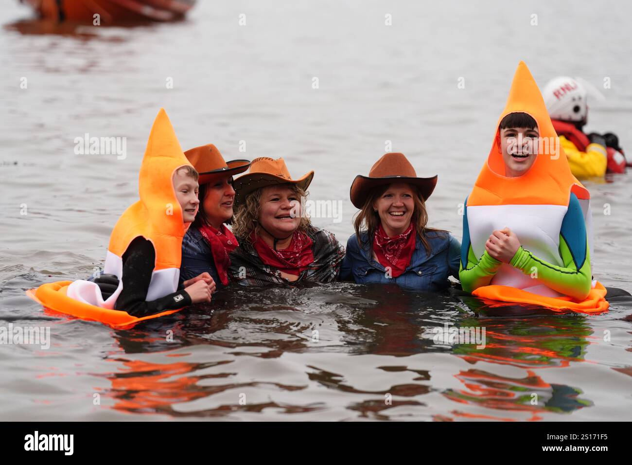 People take part in the Loony Dook New Year's Day dip in the Firth of ...