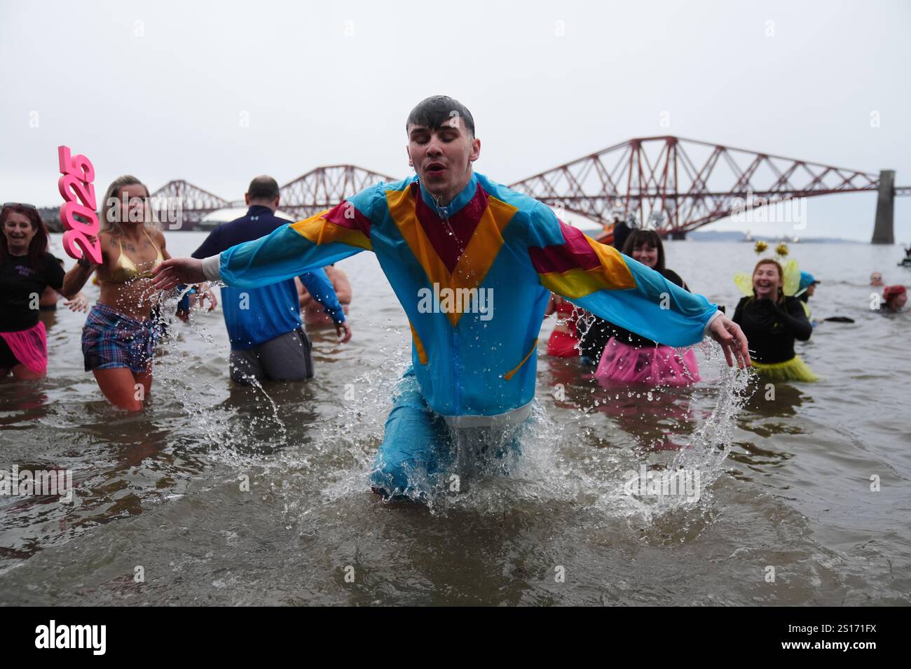 People take part in the Loony Dook New Year's Day dip in the Firth of ...