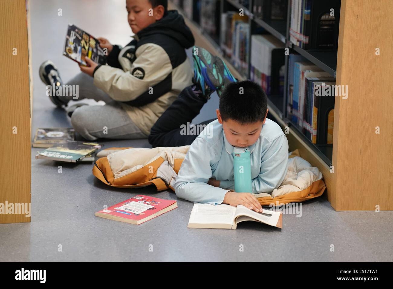 Xi'an, China's Shaanxi Province. 1st Jan, 2025. Children read at a ...