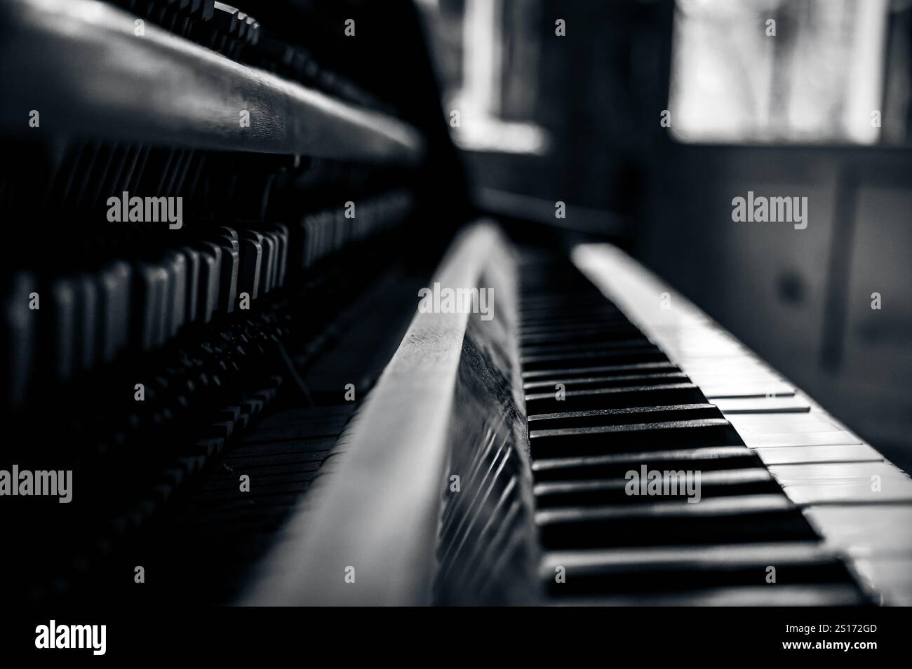 A close-up of an old piano keyboard in monochrome, capturing its worn ...
