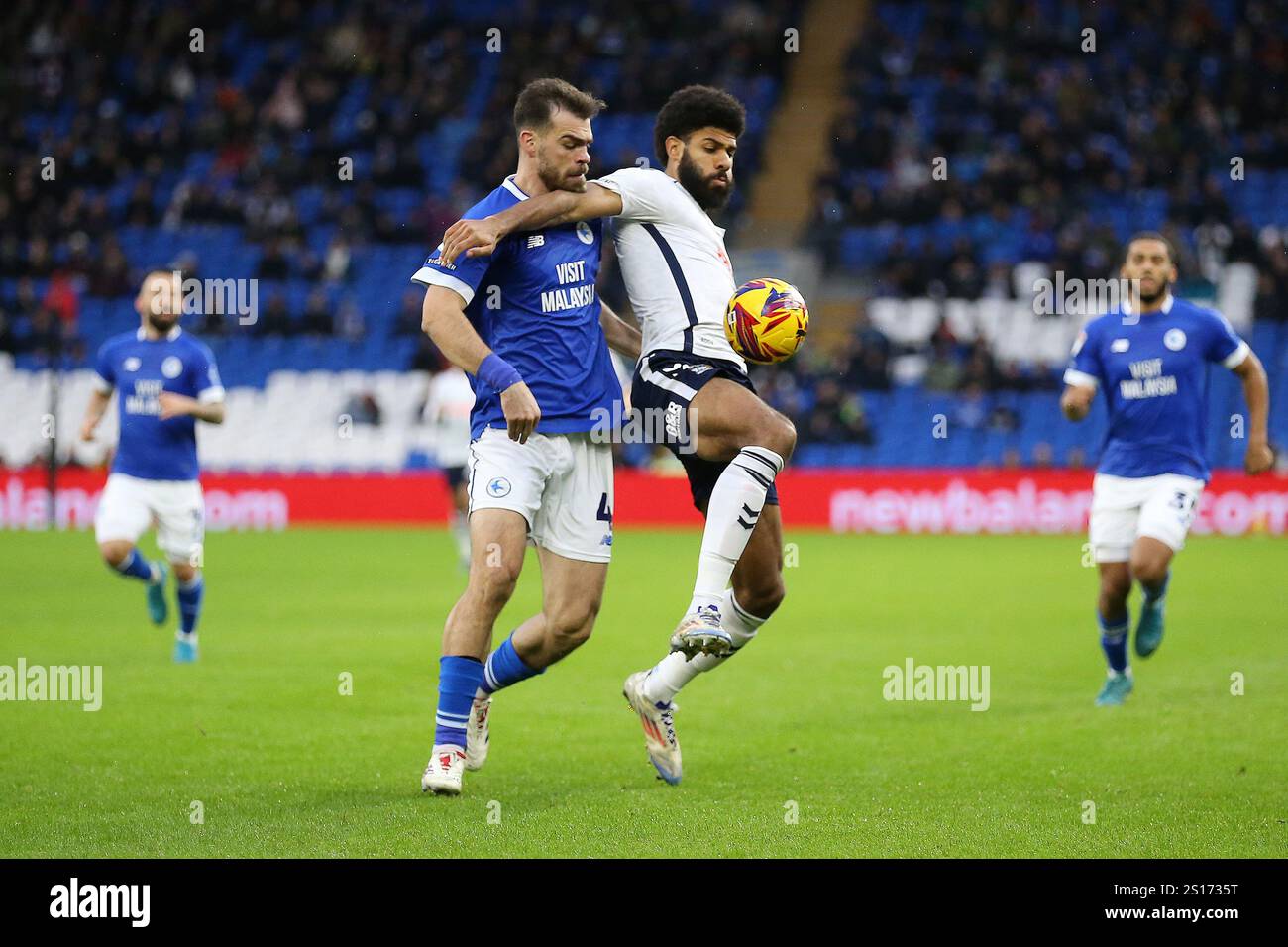 Cardiff City's Dimitris Goutas (left) and Coventry City's Ellis Simms ...