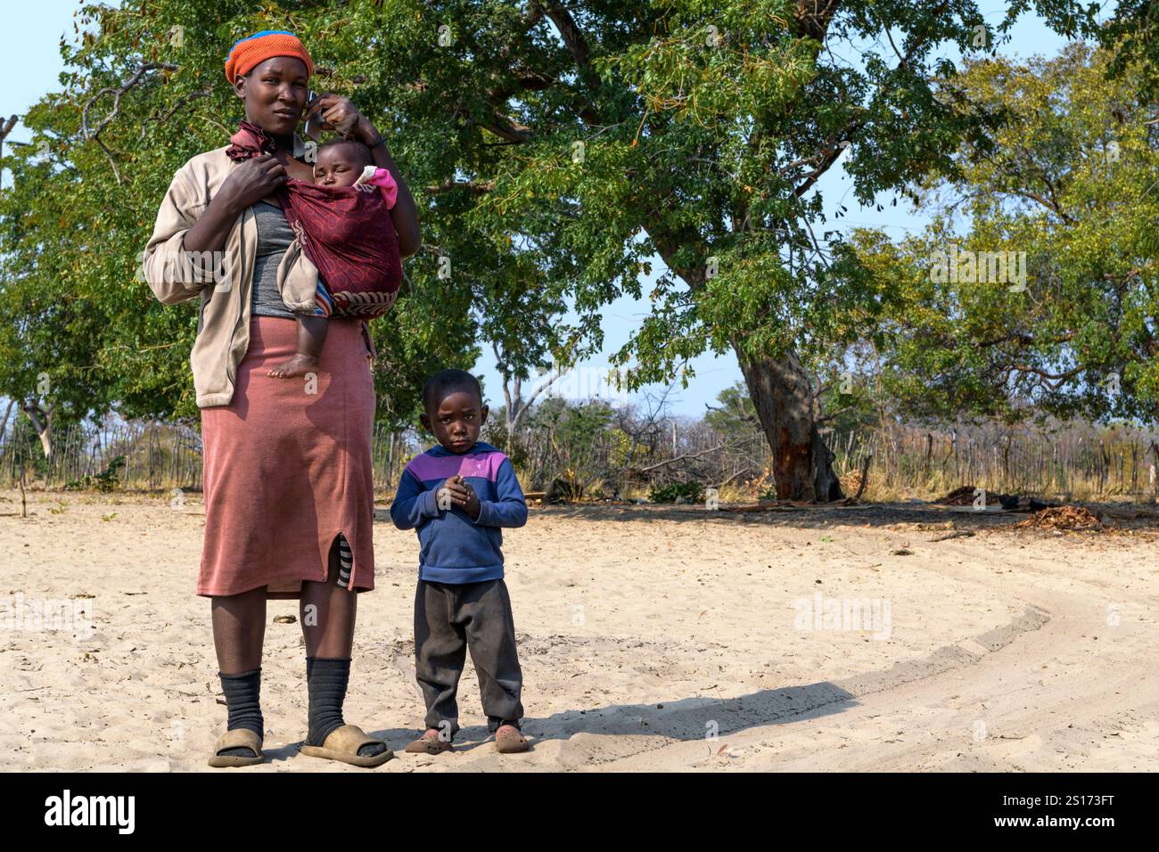 DIVUNDU, NAMIBIA - JULY 30, 2024: Namibian Woman with cell phone in her ...