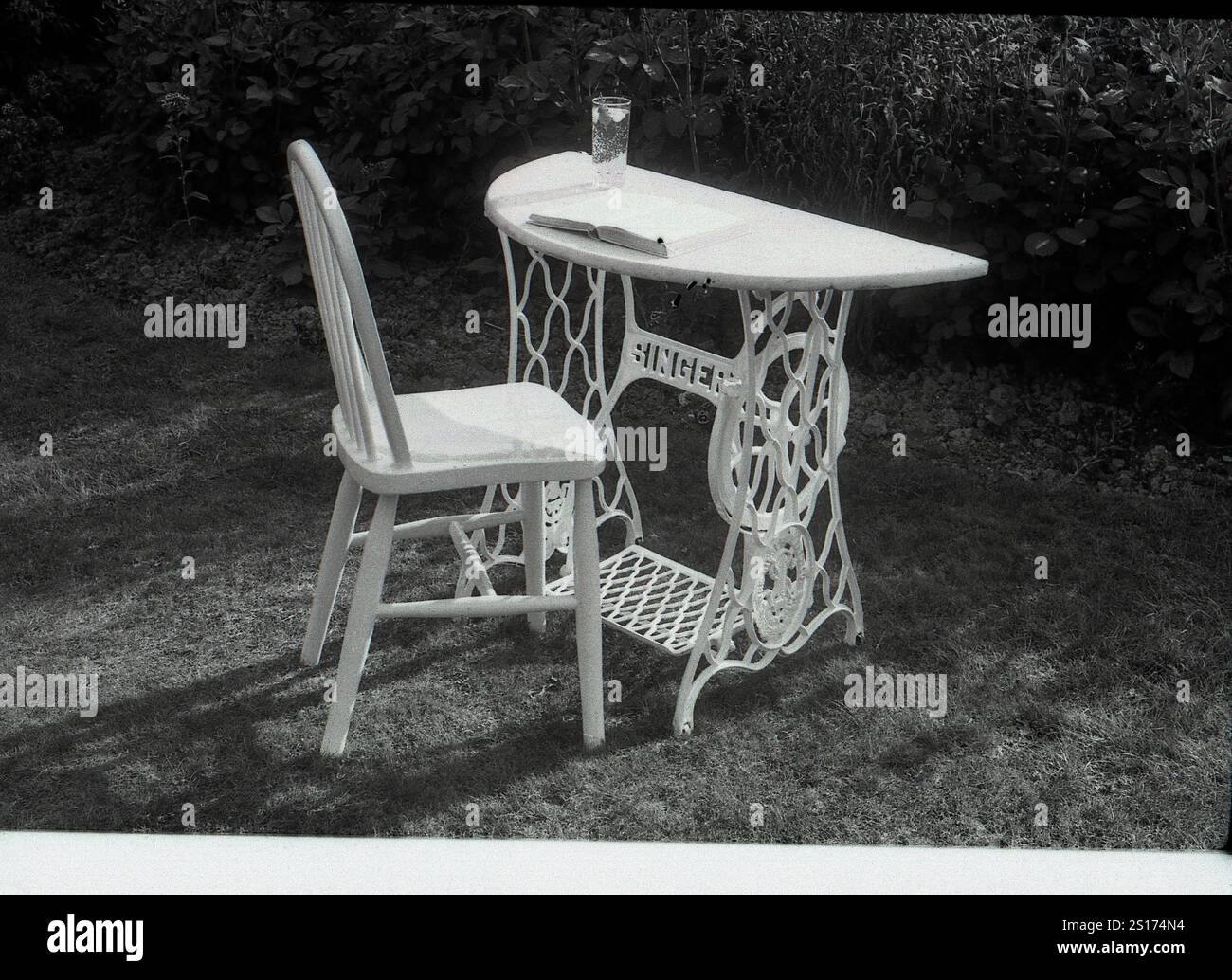 A garden table made from an old Singer sewing machine base with a ...