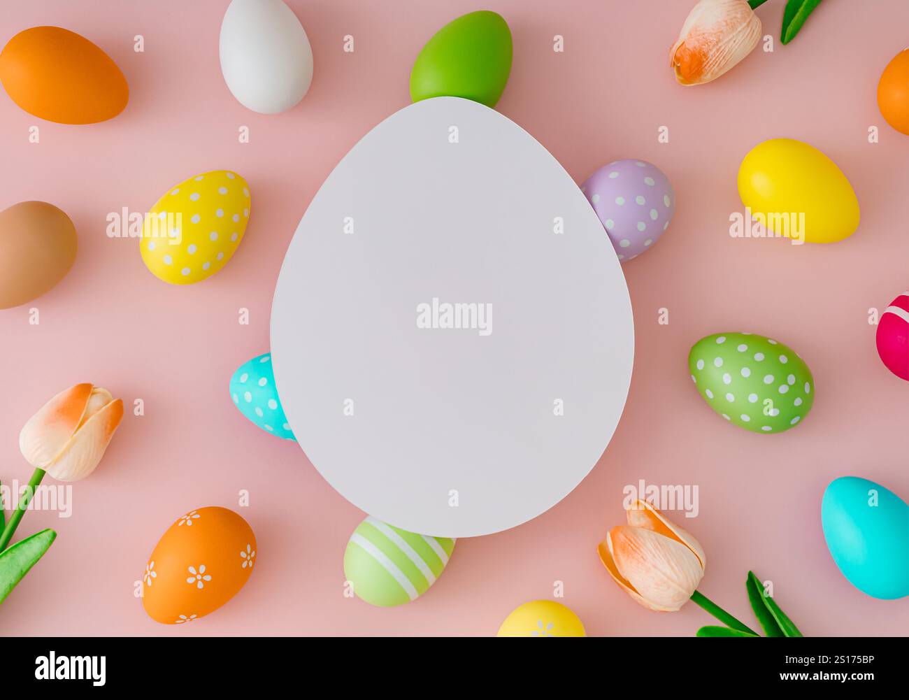 Spring pattern with colorful Easter eggs and tulip flowers on pastel ...