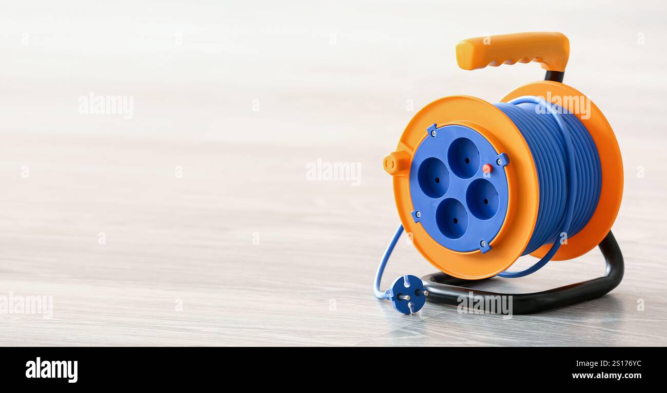 Extension cable reel on floor. Banner for design Stock Photo - Alamy