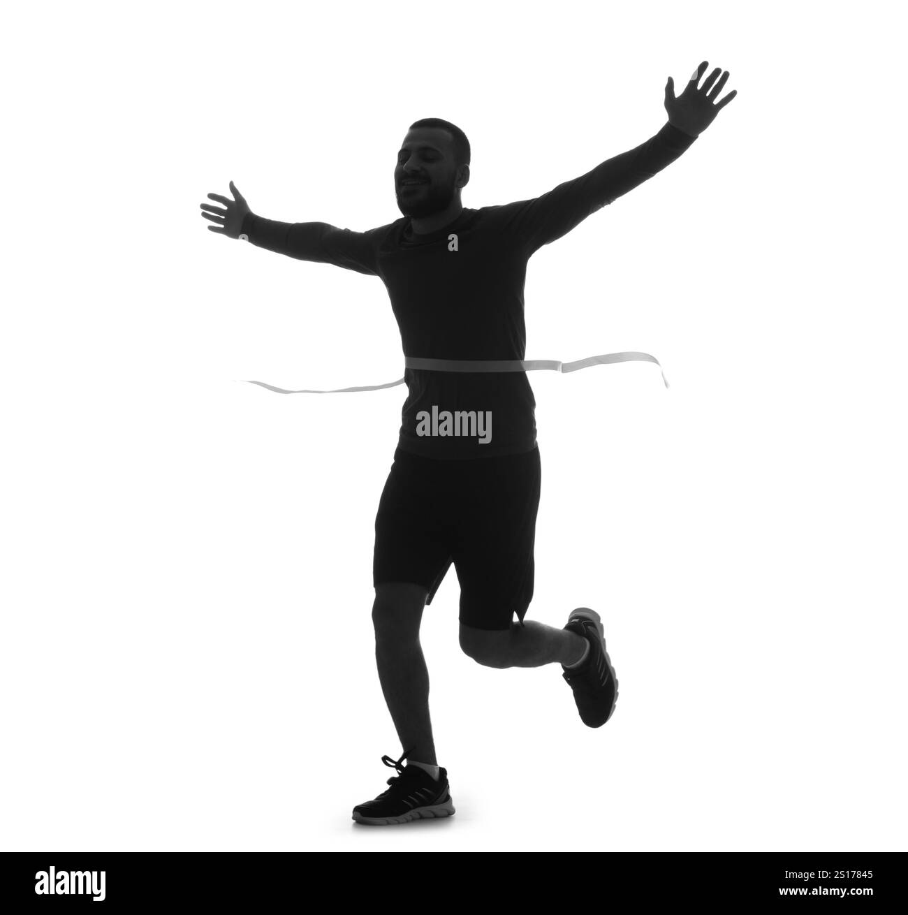 Silhouette of sporty man celebrating victory at finish line on white ...