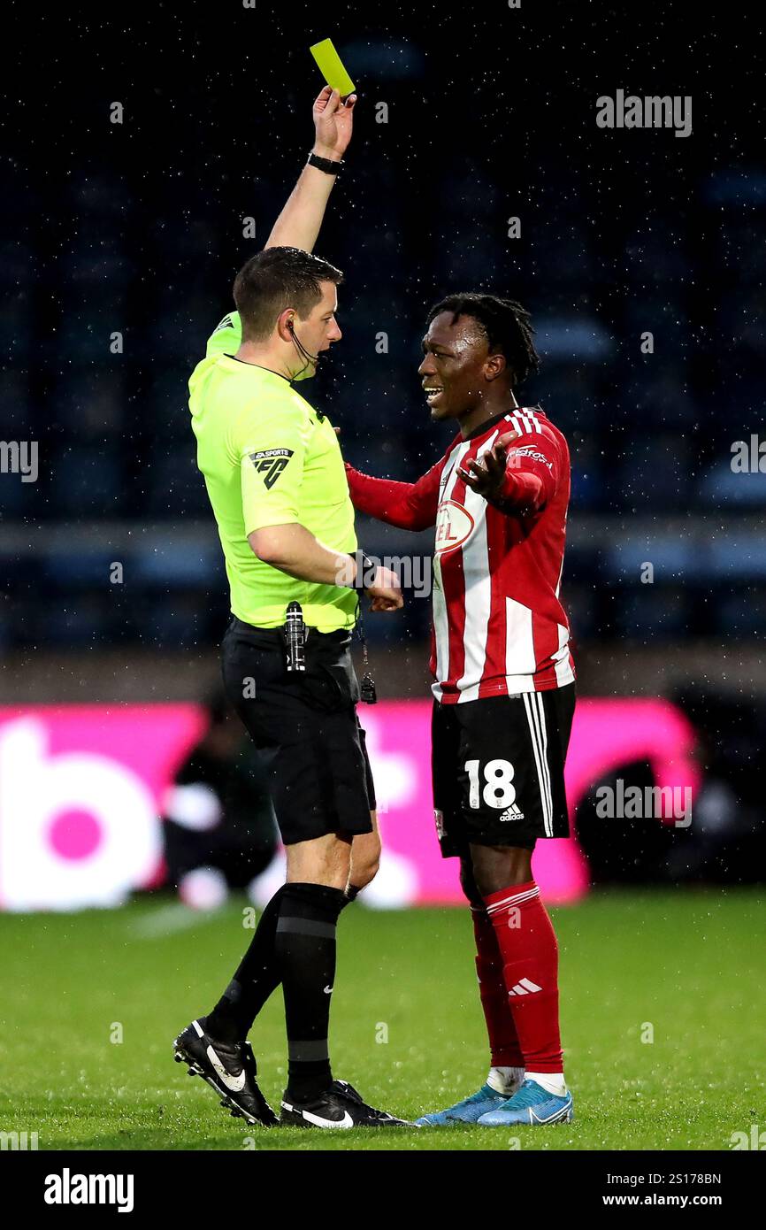 Referee Scott Simpson shows a yellow card to Exeter City's Vincent ...