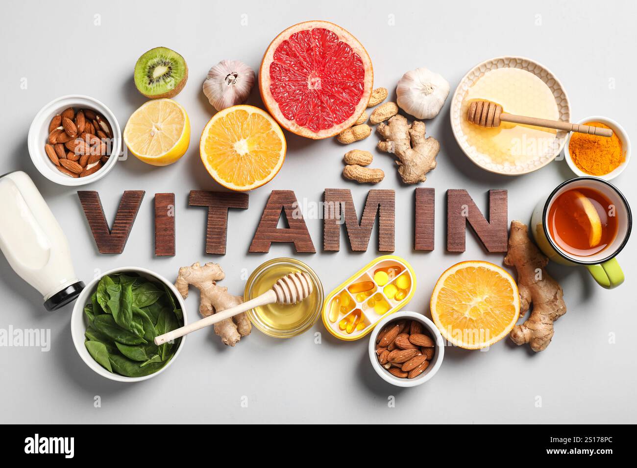 Composition with word VITAMIN made of wooden letters, pills and ...