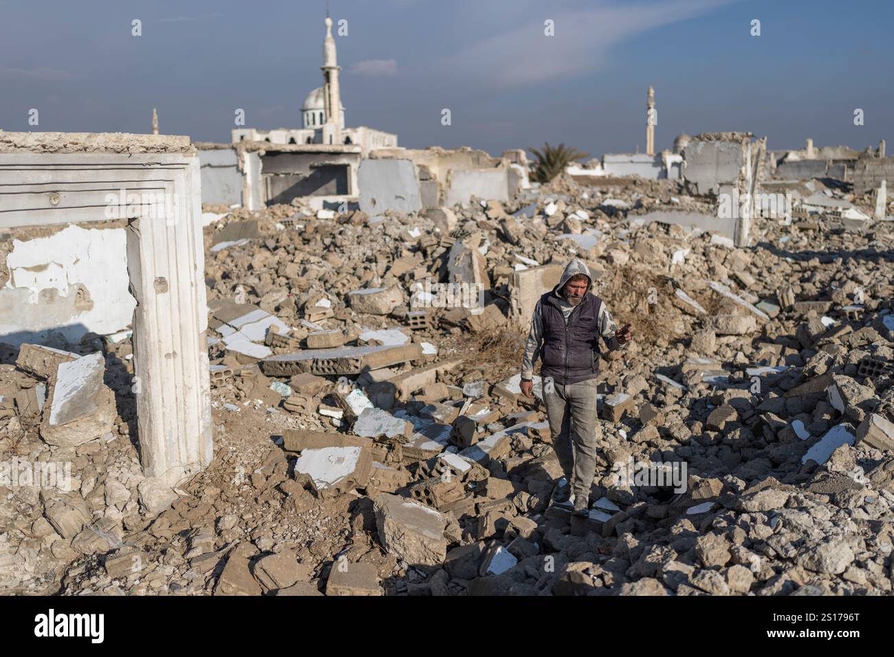 Nizar Al Hanash inspects the rubble of what used to be his home in Al ...