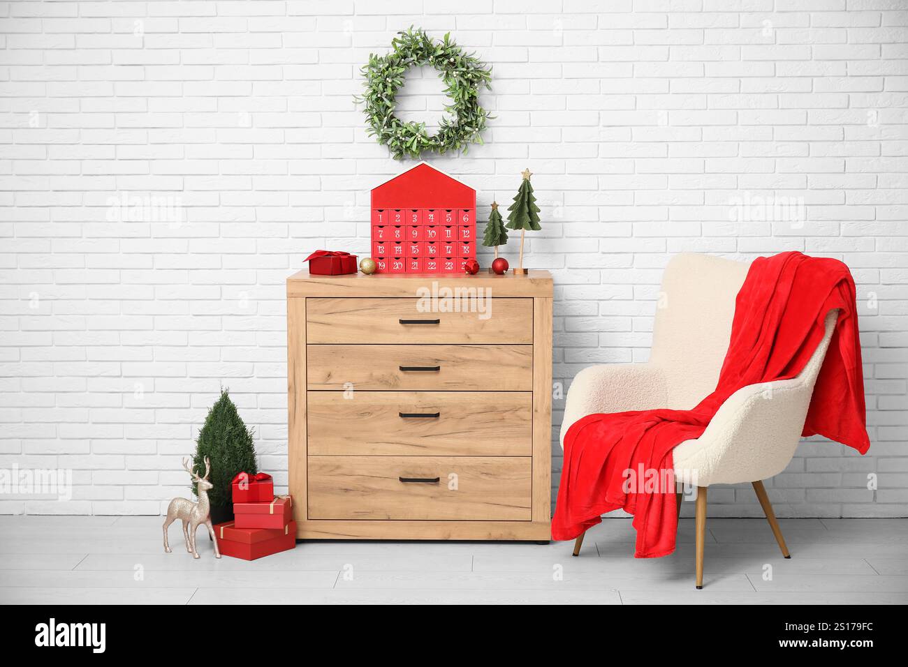 Christmas Advent calendar with decorations on chest of drawers and ...