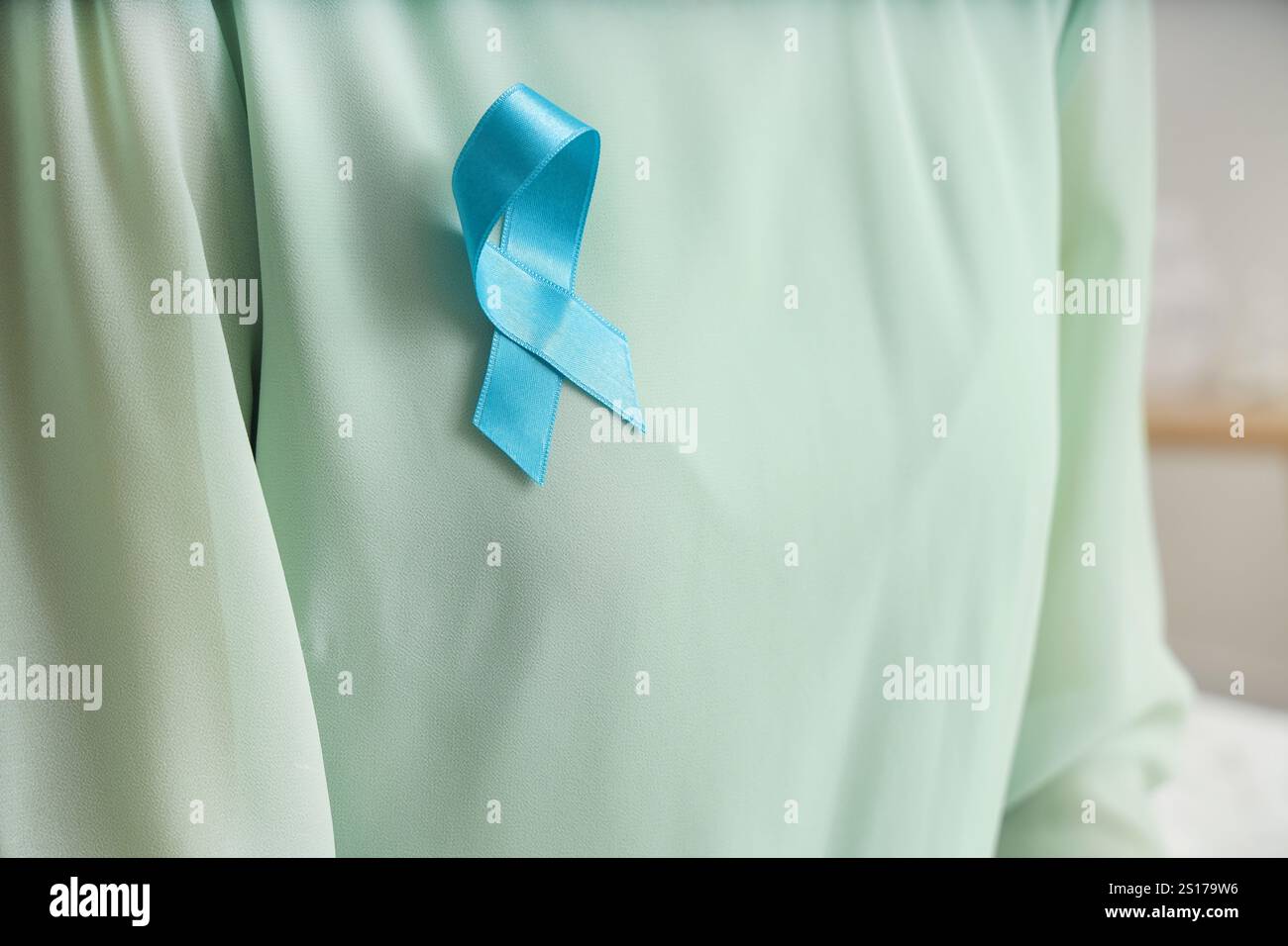 Young woman with turquoise ribbon at home, closeup. Cervical Health ...