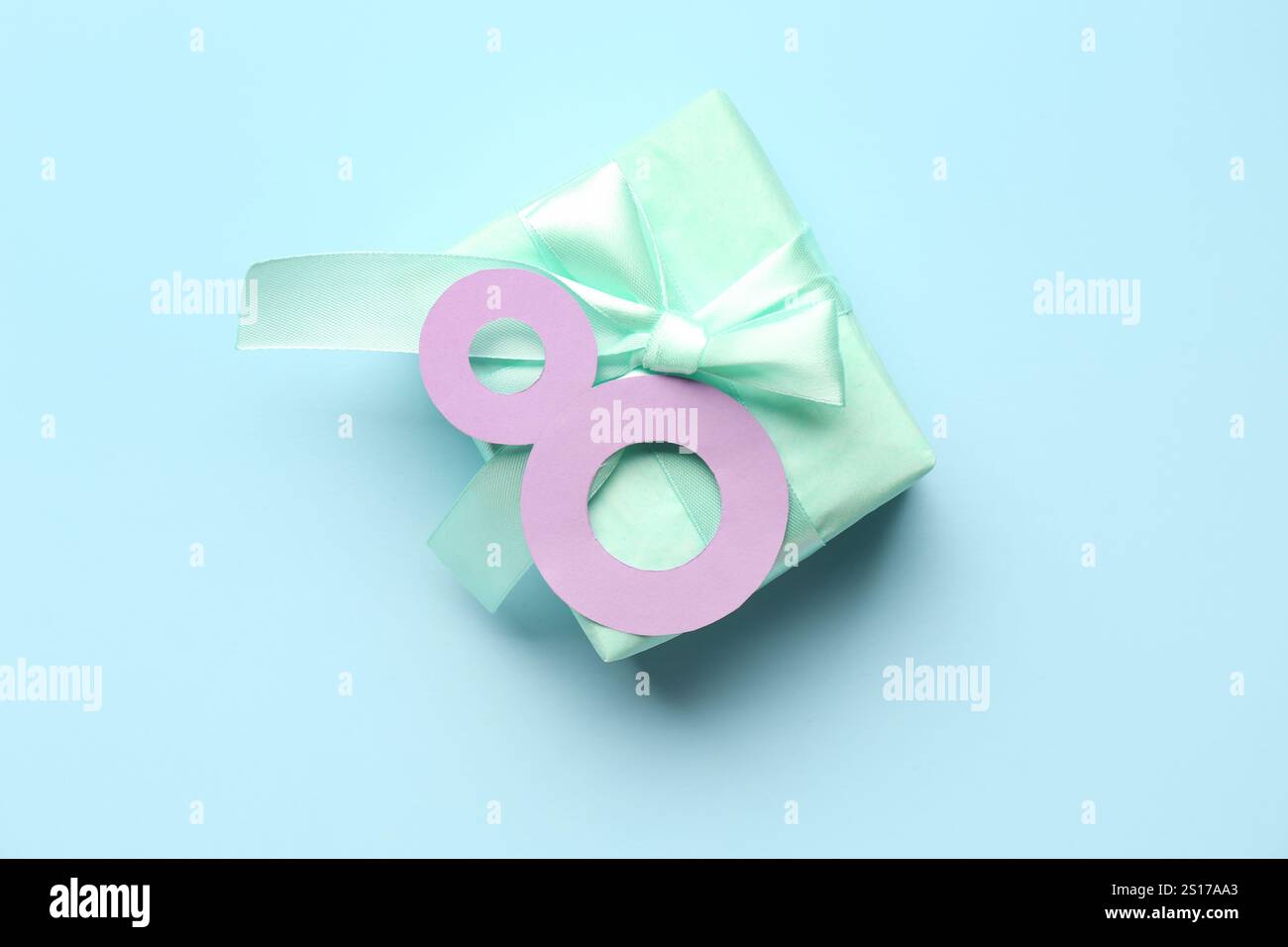 Paper figure 8 with gift box on blue background. Happy Women's Day ...