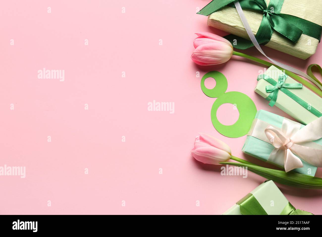 Paper figure 8 with gift boxes and tulips on pink background. Happy ...