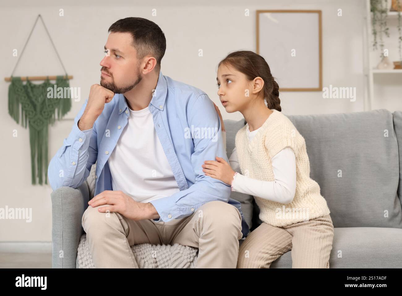 Cute girl apologizing to her father on sofa at home Stock Photo - Alamy