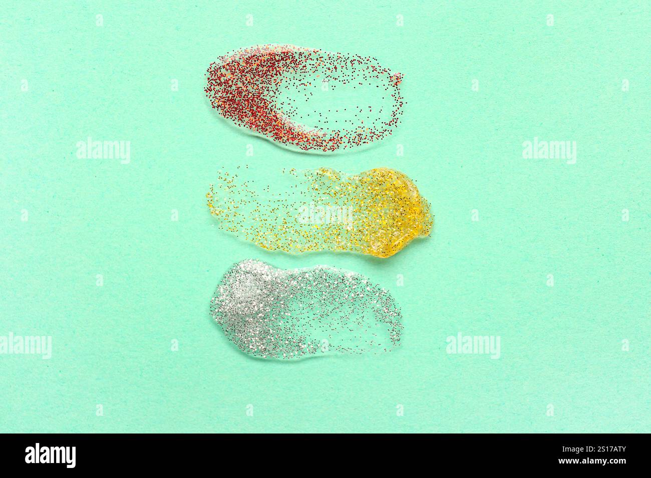 Different glitter strokes on green background Stock Photo - Alamy