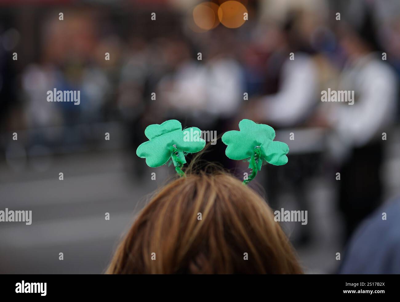 A girl wears the symbol of shamrocks and the colour green on her tiara ...