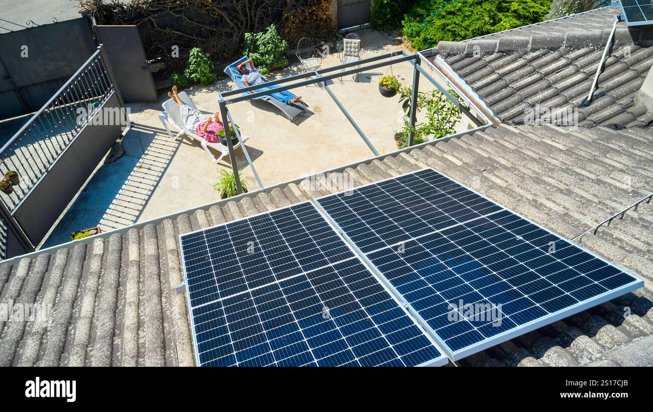 An aerial view shows two women sunbathing in a sunny backyard while ...