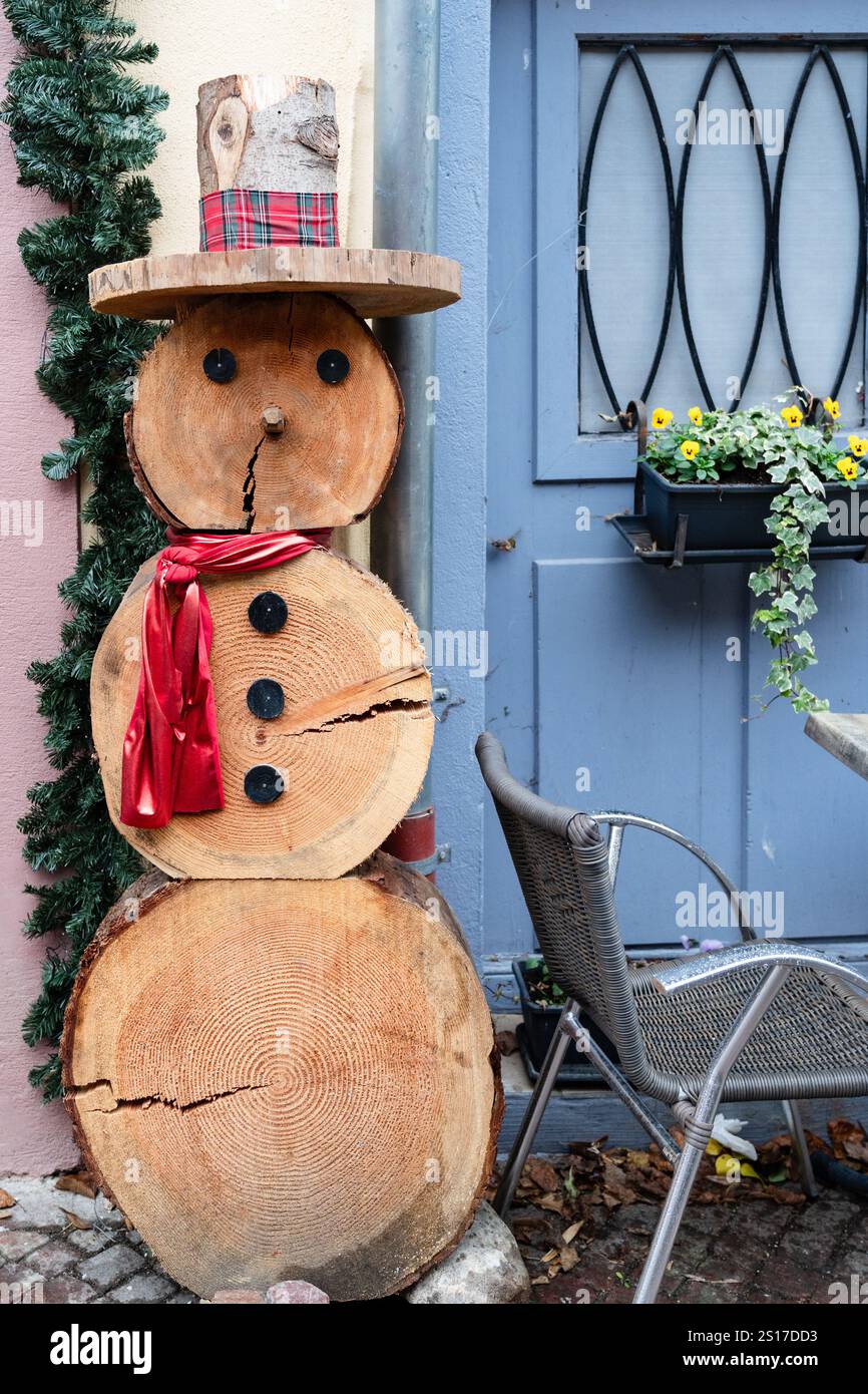 Cute snowman made of logs, Christmas decoration on an outdoor patio ...