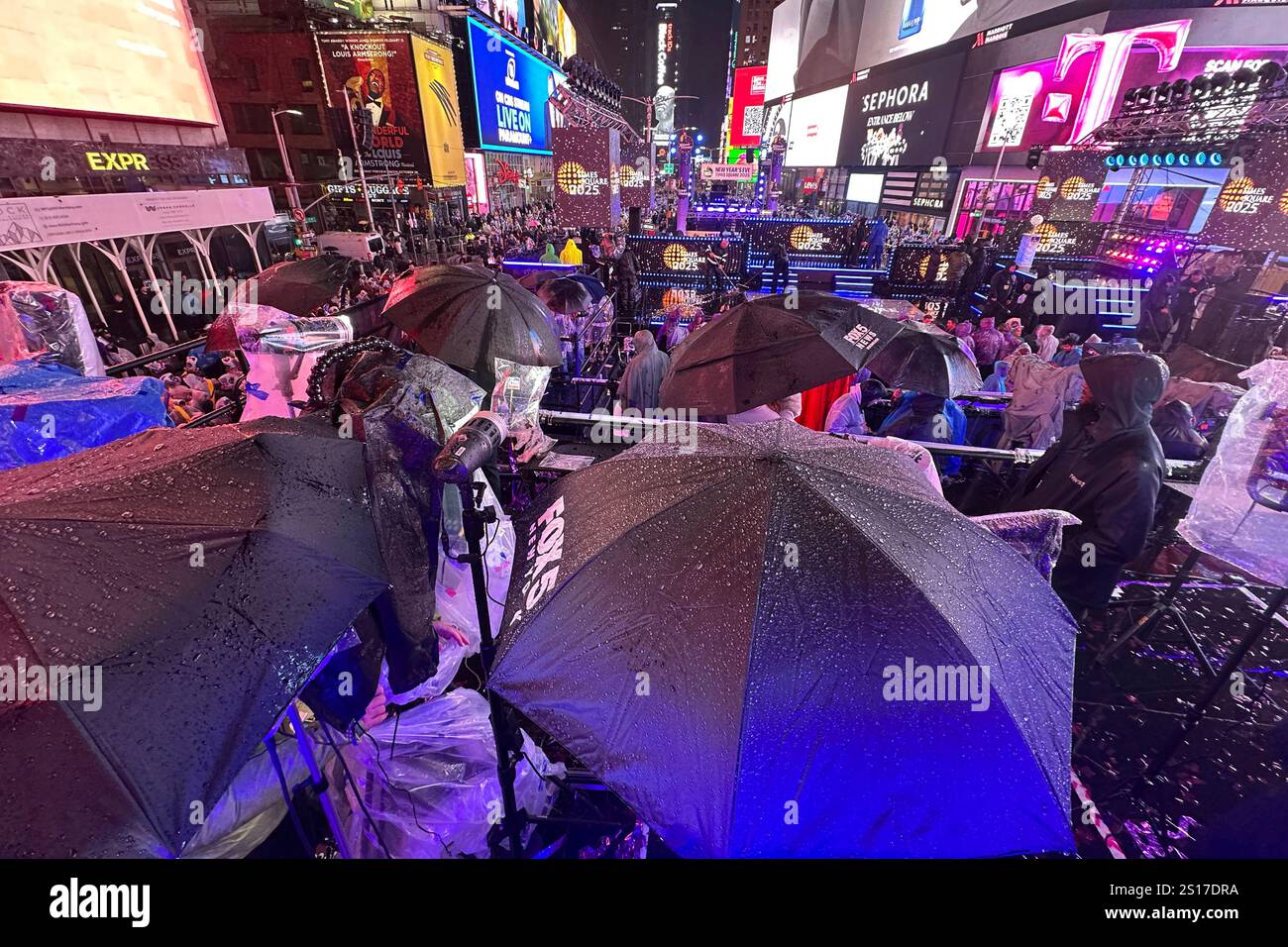 Revelers, police and the media are in a rainy Times Square in New York ...