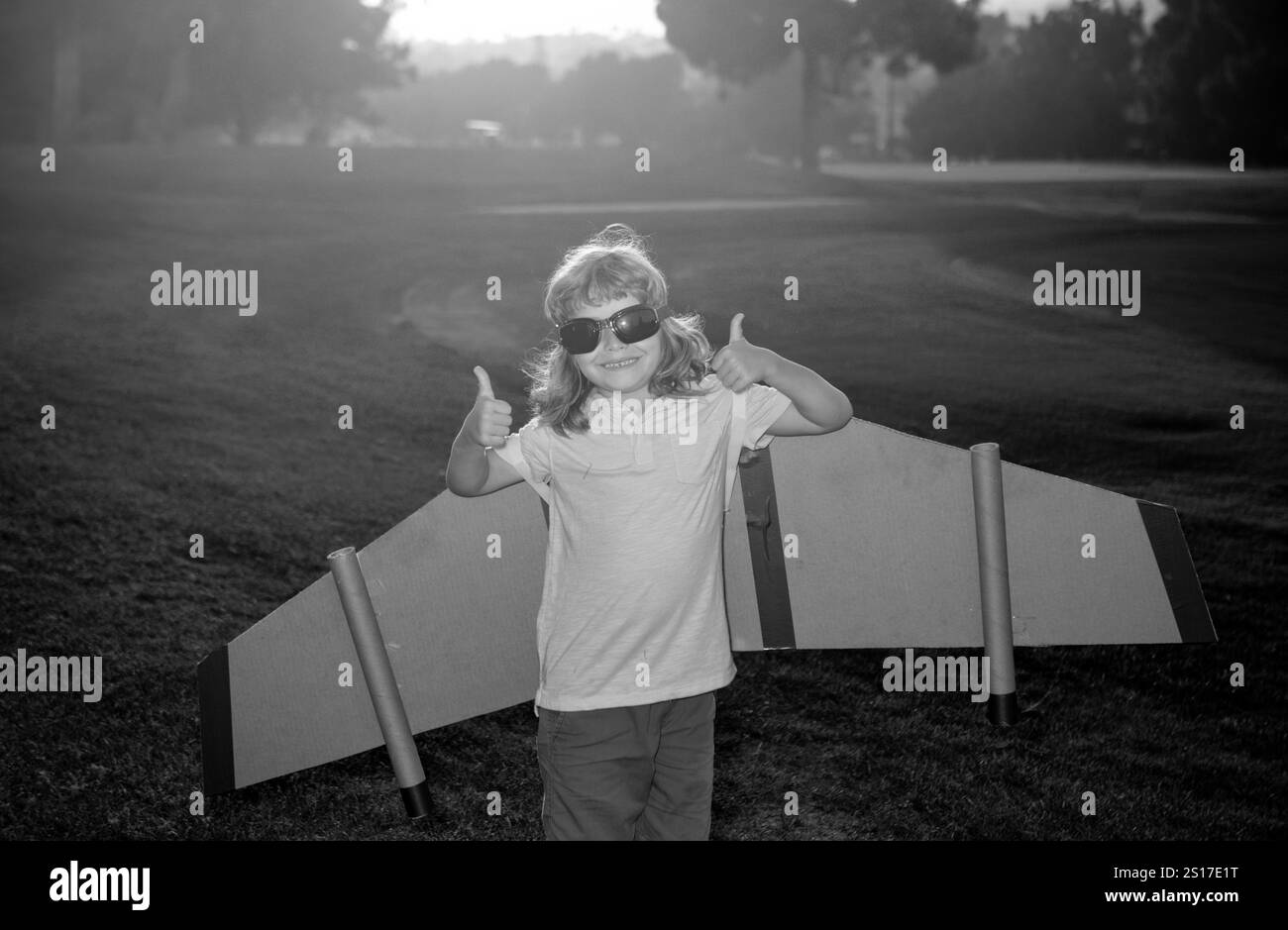 Child dreams of becoming a rocket pilot at sunset. Imagination and ...