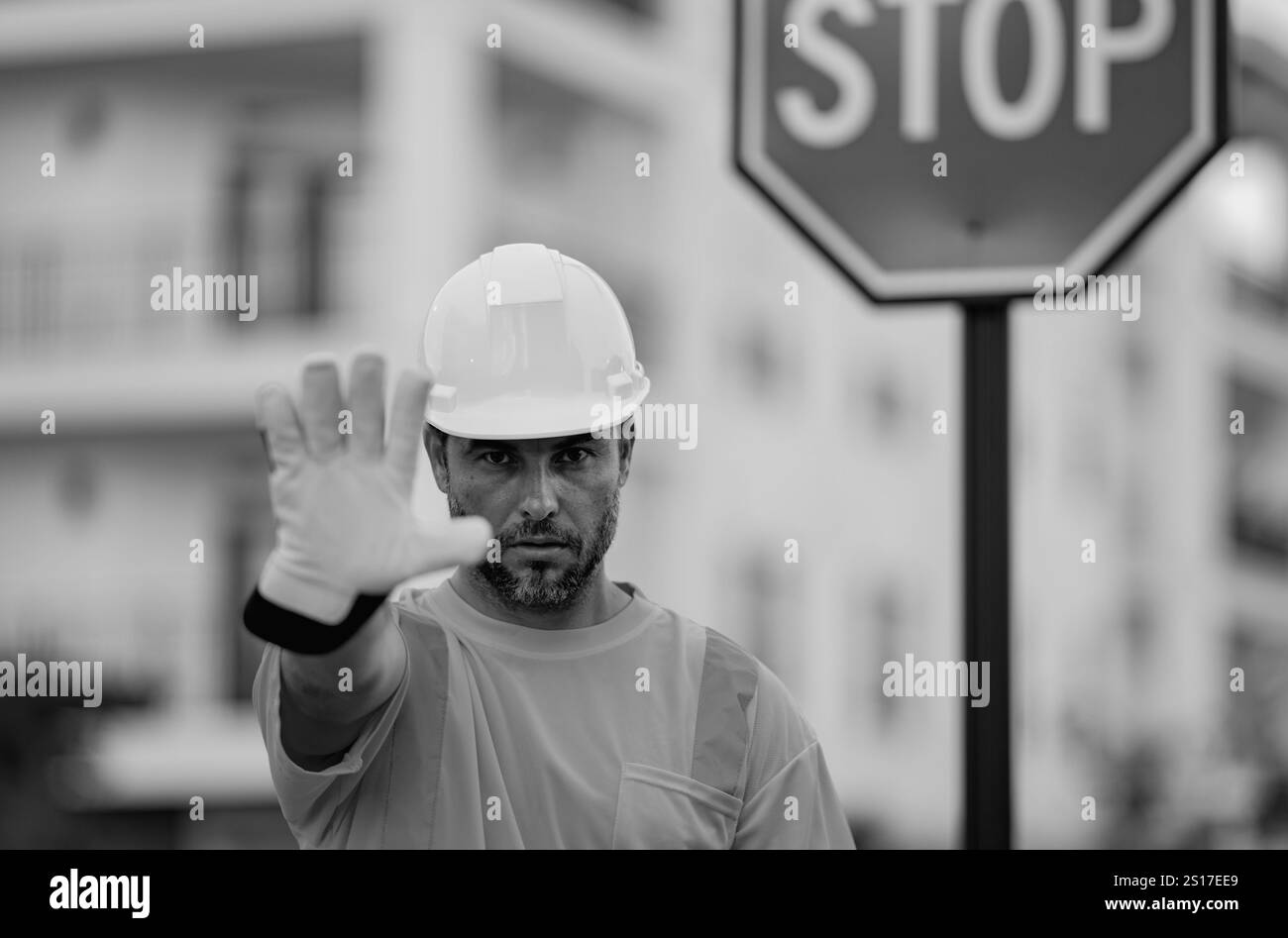 Man in worker uniform and hardhat with open hand doing stop sign with ...