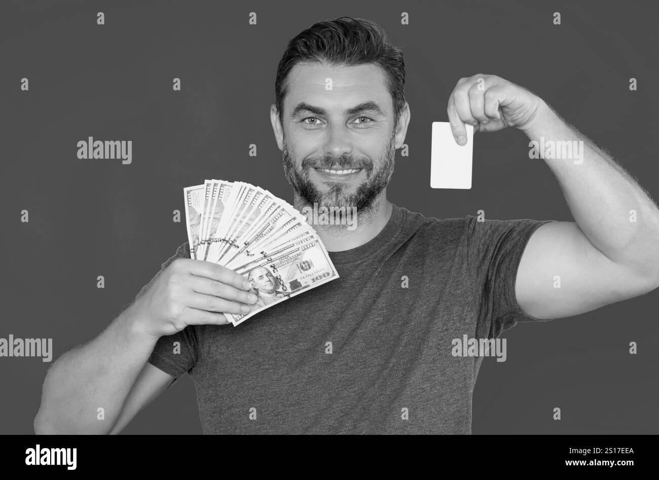 Smiling man holding dollar bills Black and White Stock Photos & Images ...