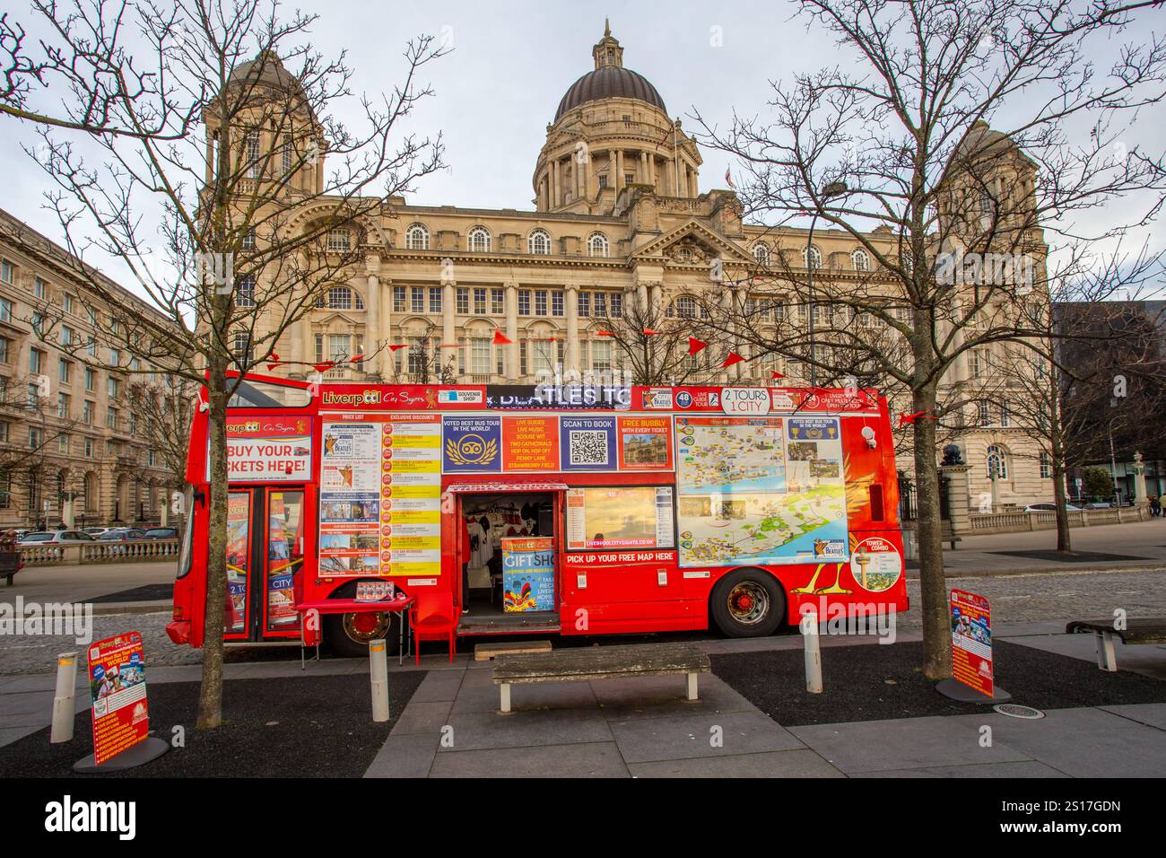 Red double decker open top tour bus in front of the The Port of ...