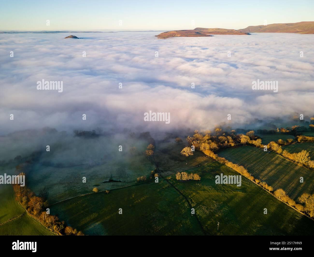 Aerial view of thick fog and long shadows from trees in the Brecon ...