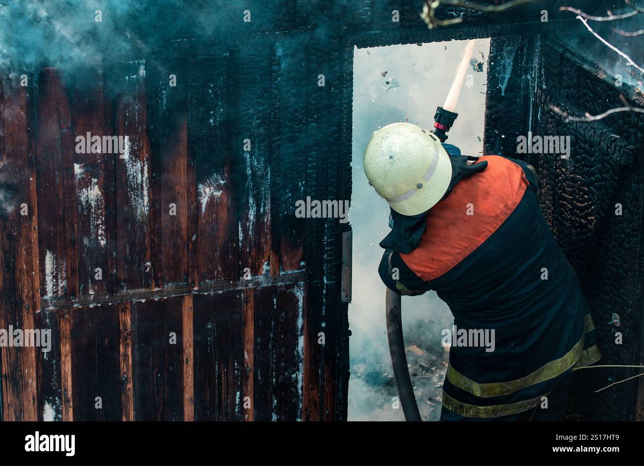 Firefighter work concept. Firefighter are using water in fire fighting ...