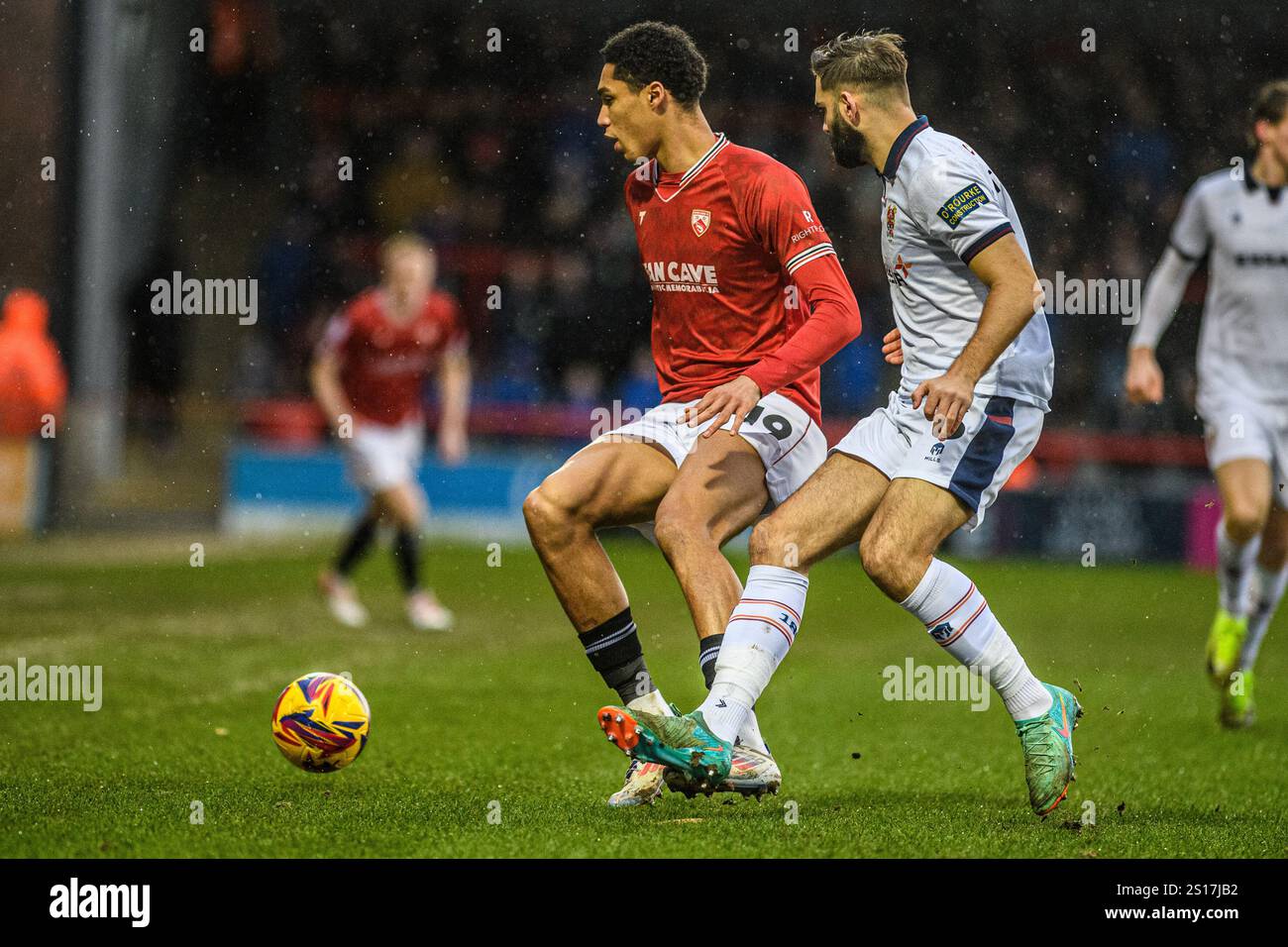 Jordan Turnbull of Tranmere Rovers FC tackles Morecambe FC's Marcus ...
