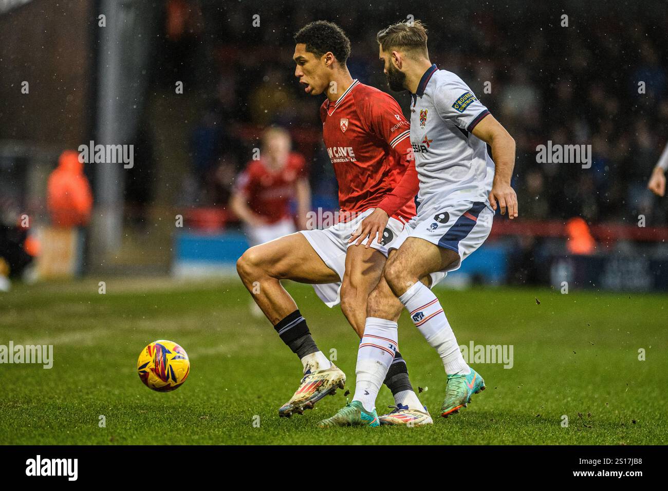 Jordan Turnbull of Tranmere Rovers FC tackles Morecambe FC's Marcus ...