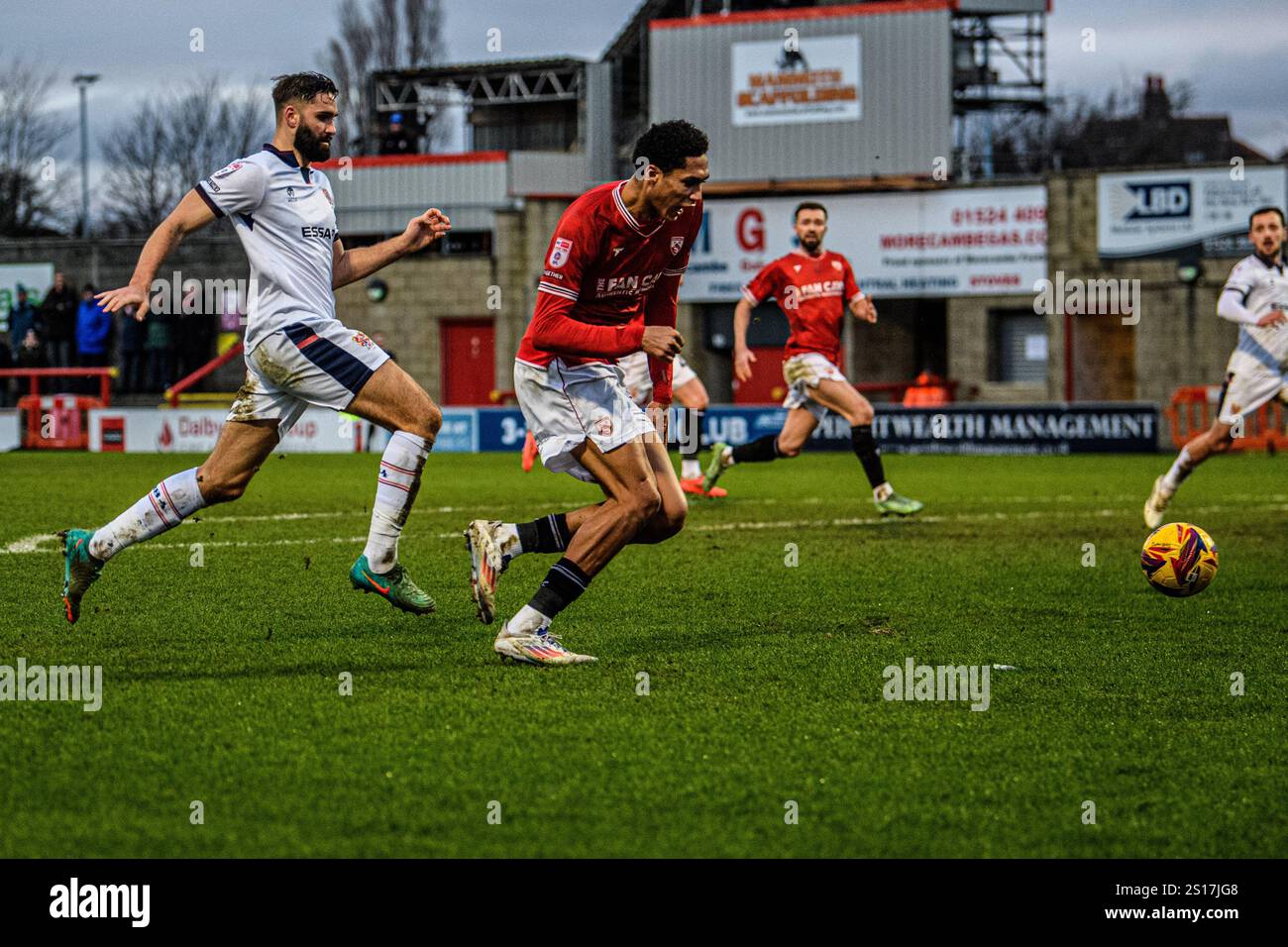Morecambe FC's Marcus Dackers under pressure from Jordan Turnbull of ...