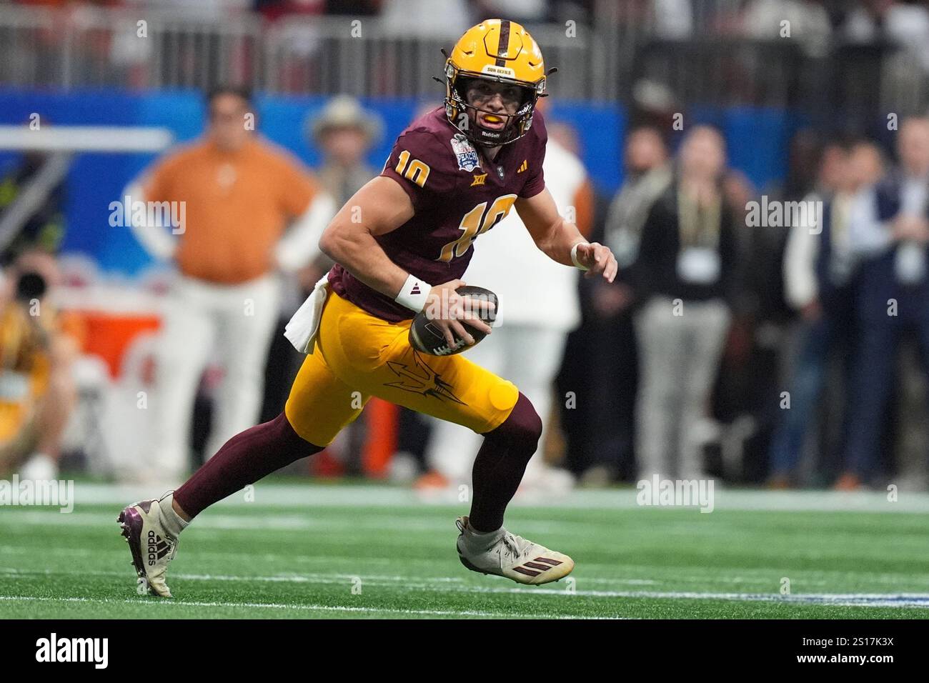 Arizona State quarterback Sam Leavitt (10) rns out of the pocket ...