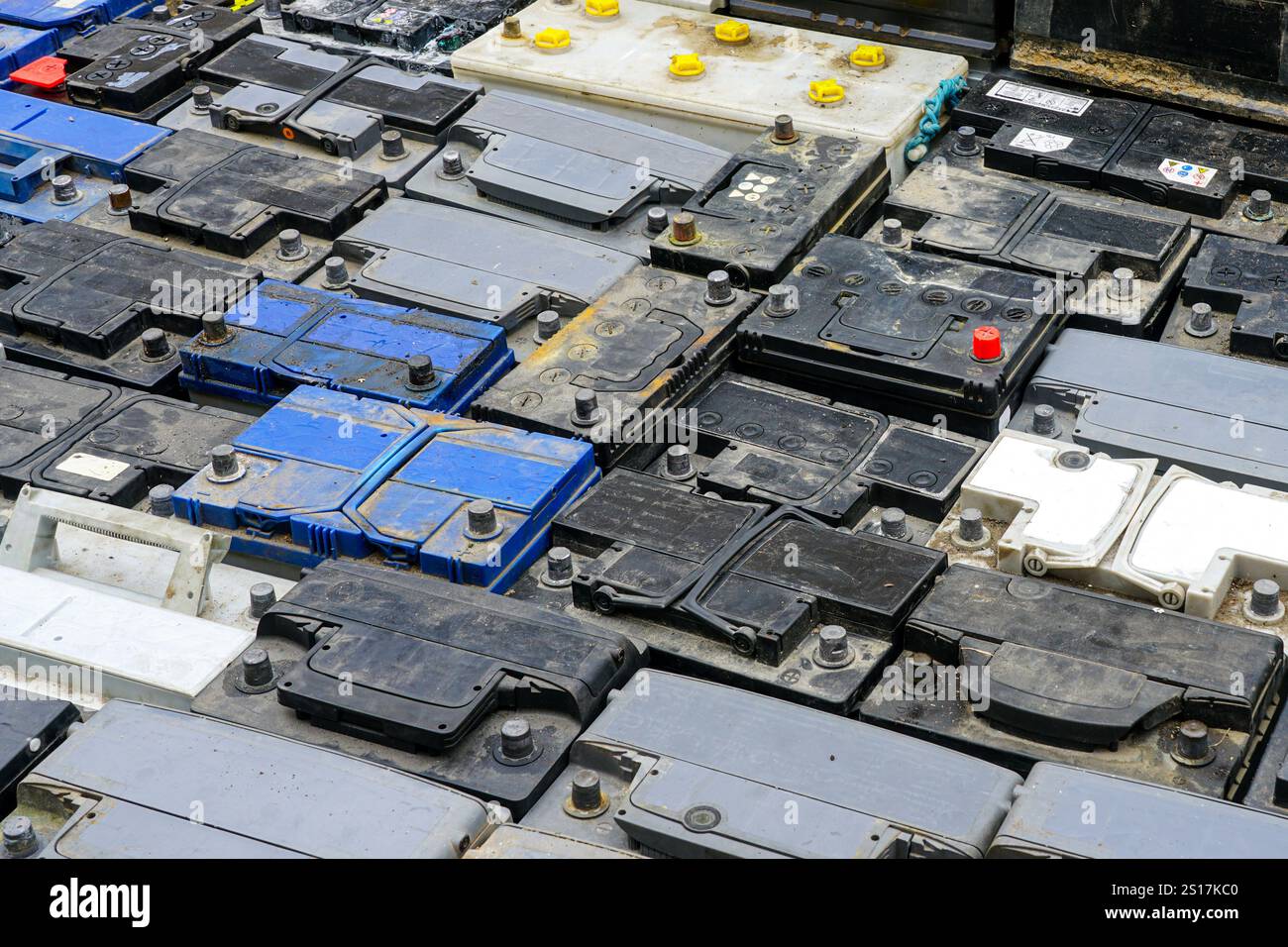 Stack of many used car batteries for recycling in a hazardous waste ...