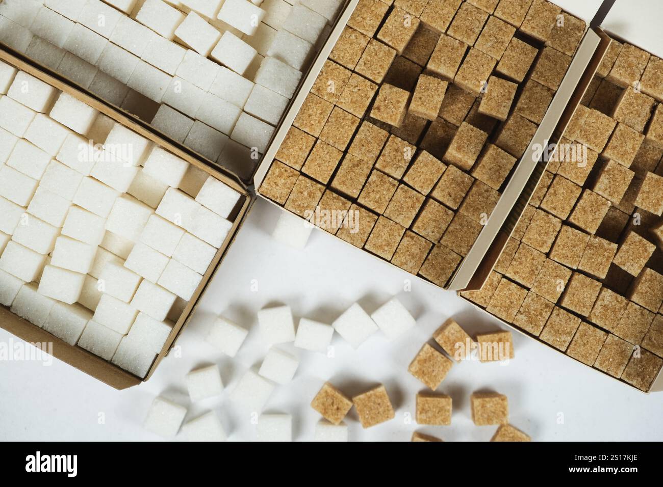 Cubes of demerara cane sugar and white beet sugar top view Stock Photo ...