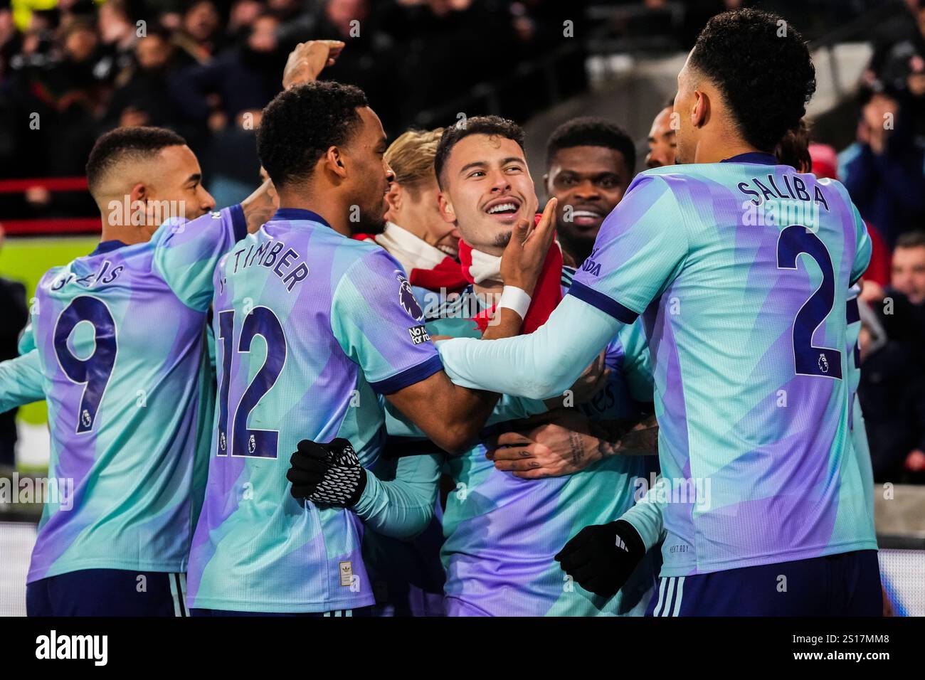 Arsenal's Gabriel Martinelli, center, is congratulated by teammates ...