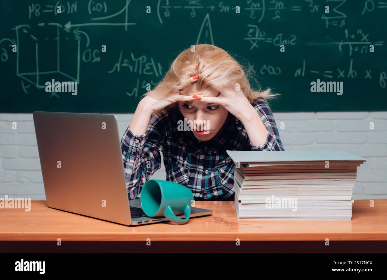 Back to school. Girl stressed by studying to hard screaming classroom ...