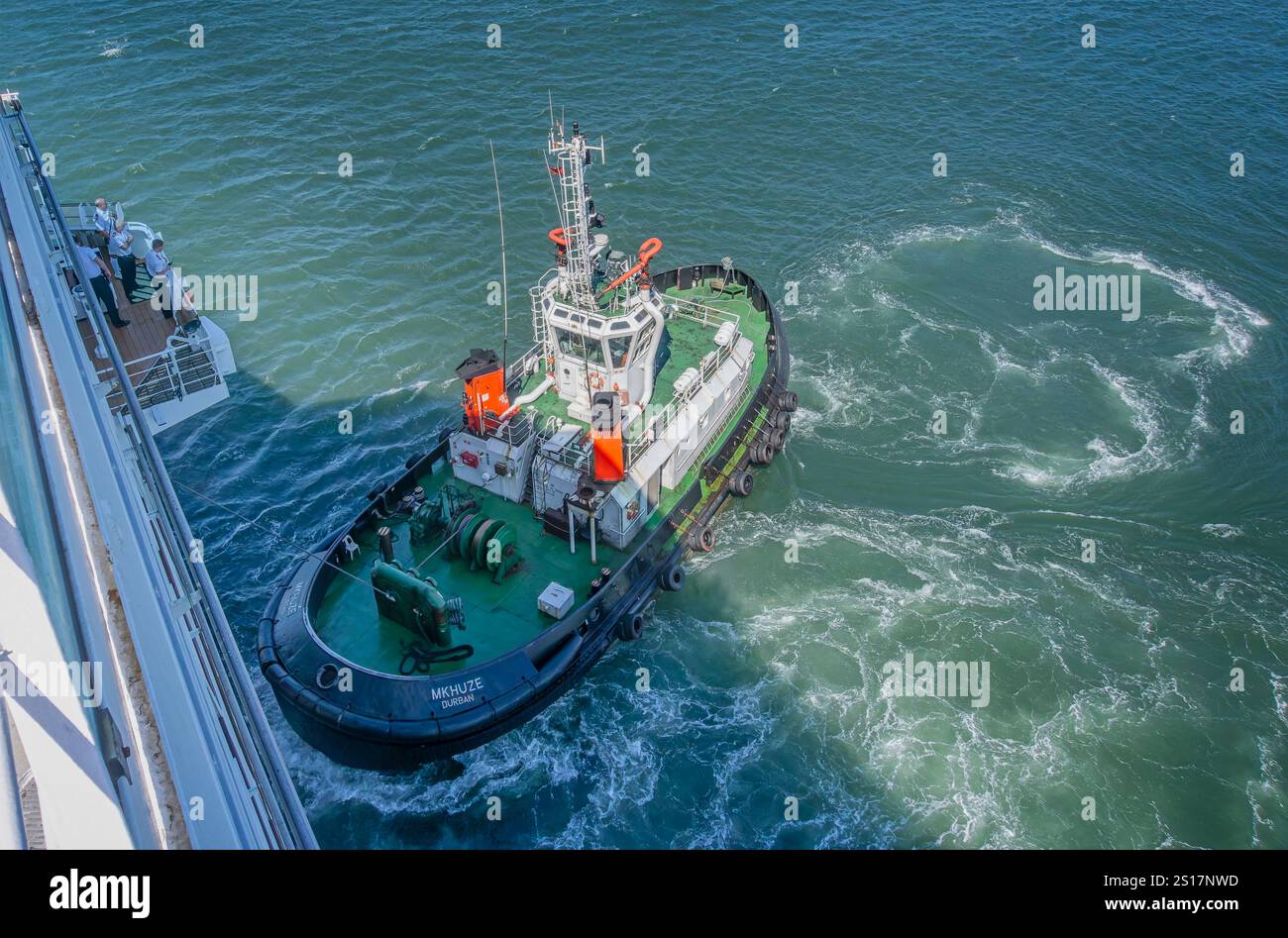 Tug Mkhuze helping cruise ship Azamara Quest dock at Durban in windy ...