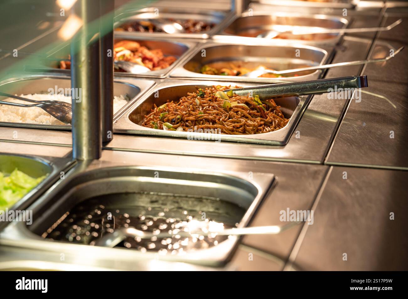 Asian food buffet in restaurant multiple food dishes and salad. Eat as ...