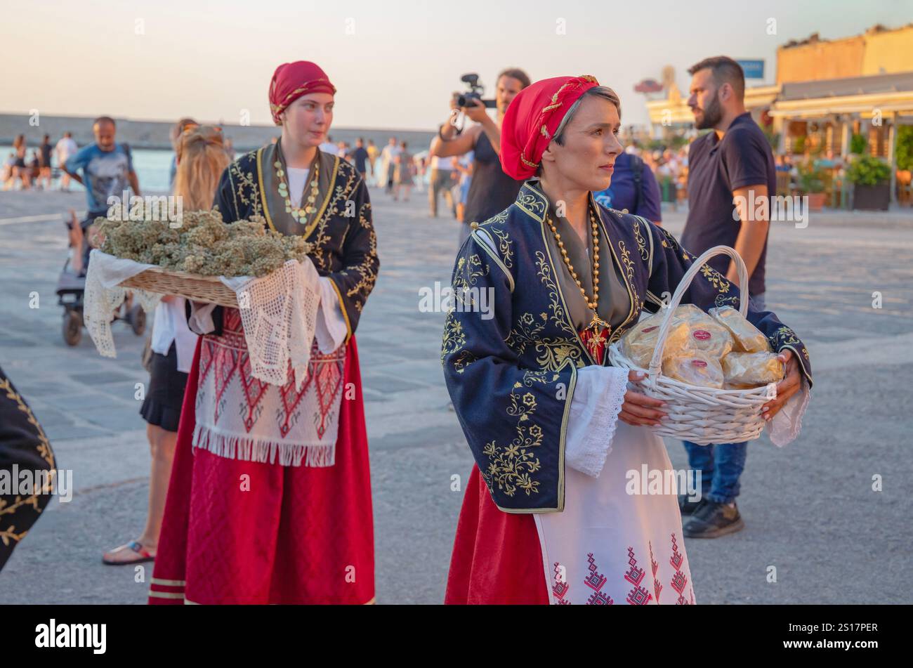 Traditionally dressed Greek women carrying gifts during marriage ...