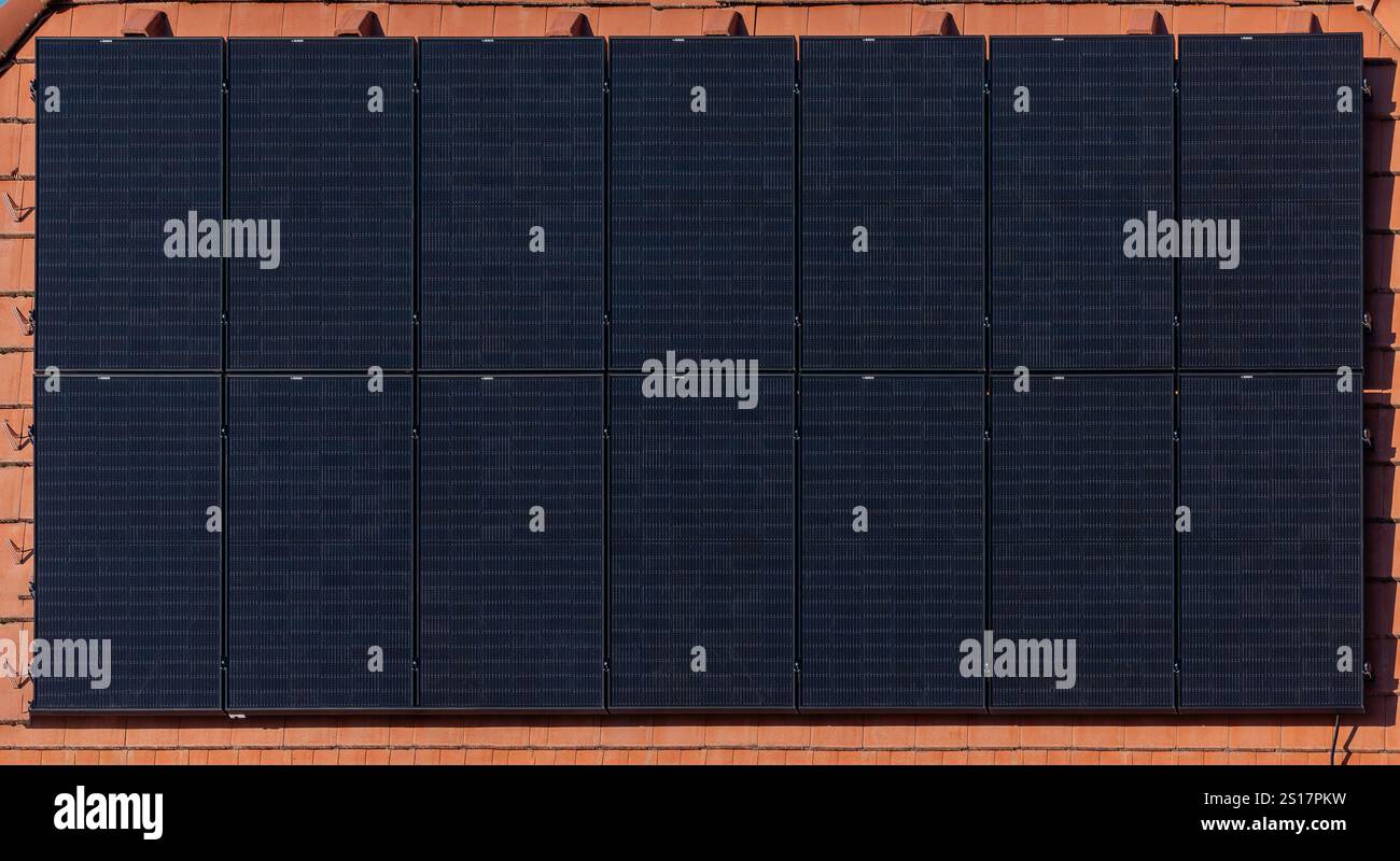 Multiple solar panels for electricity installed on a red tile wall of ...