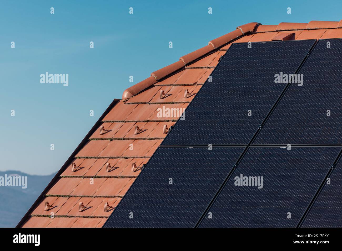 Multiple solar panels for electricity installed on a red tile wall of ...