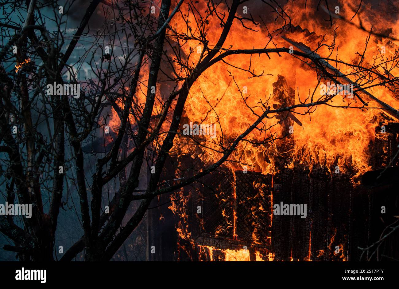 A house on fire and burning down. Totally engulfed. Fire in the house. House fire in the night ...