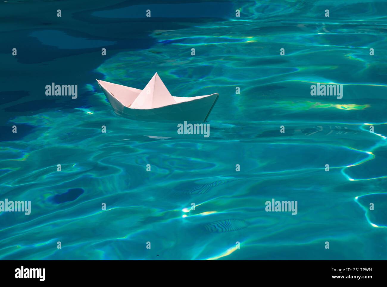 Paper boat sailing on blue water surface. Paper boat on the sea ...