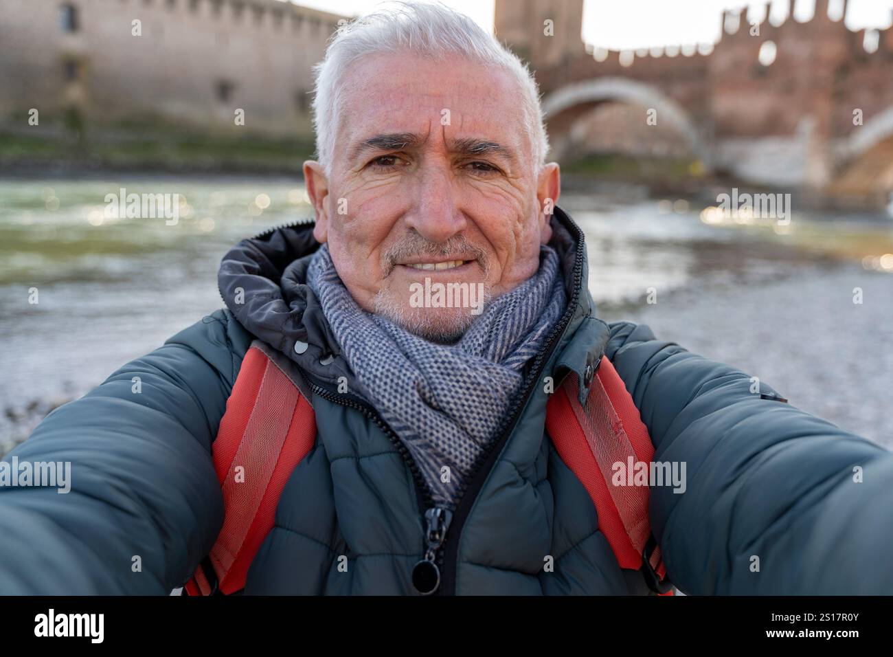 happy middle aged man on vacation taking a selfie on a river beach in ...
