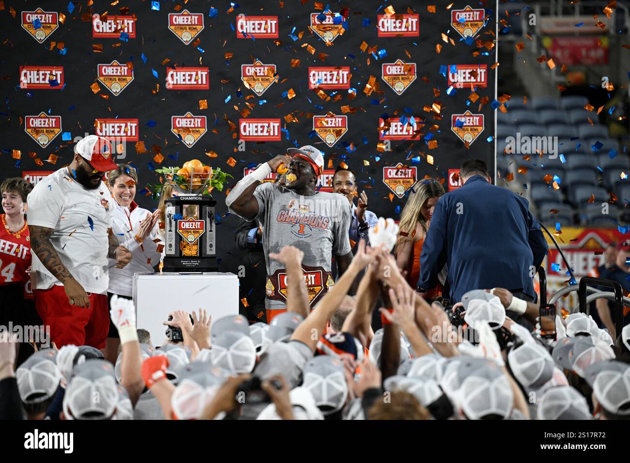 Illinois MVP running back Josh McCray, center, bites an orange on the ...