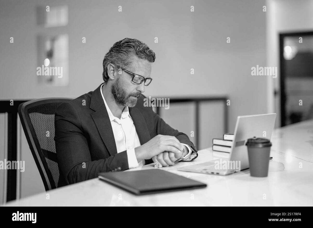 Working on computer looking clock Black and White Stock Photos & Images - Alamy